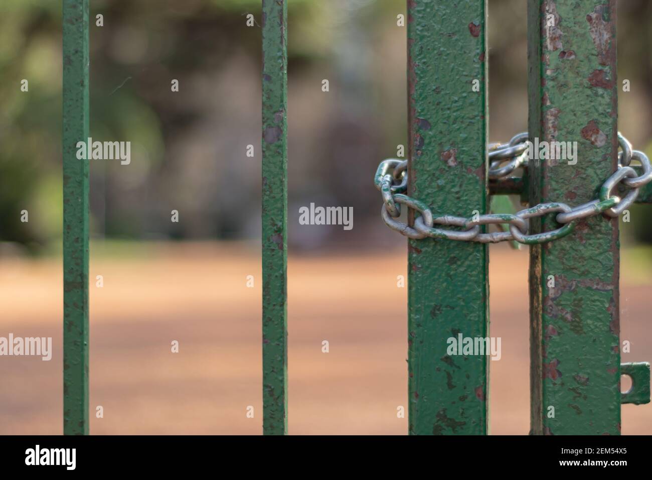 Green metal gate with chain Stock Photo - Alamy