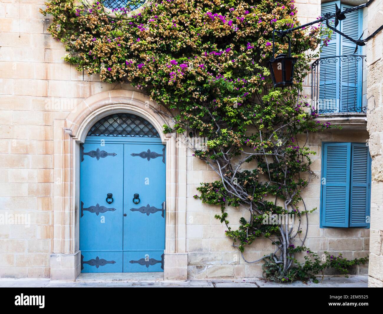 Traditional Maltese house with windows and blue door in the walled city ...