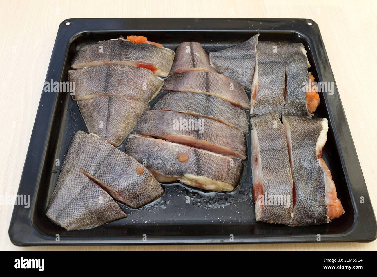 Fish on a metal tray for baking Stock Photo - Alamy