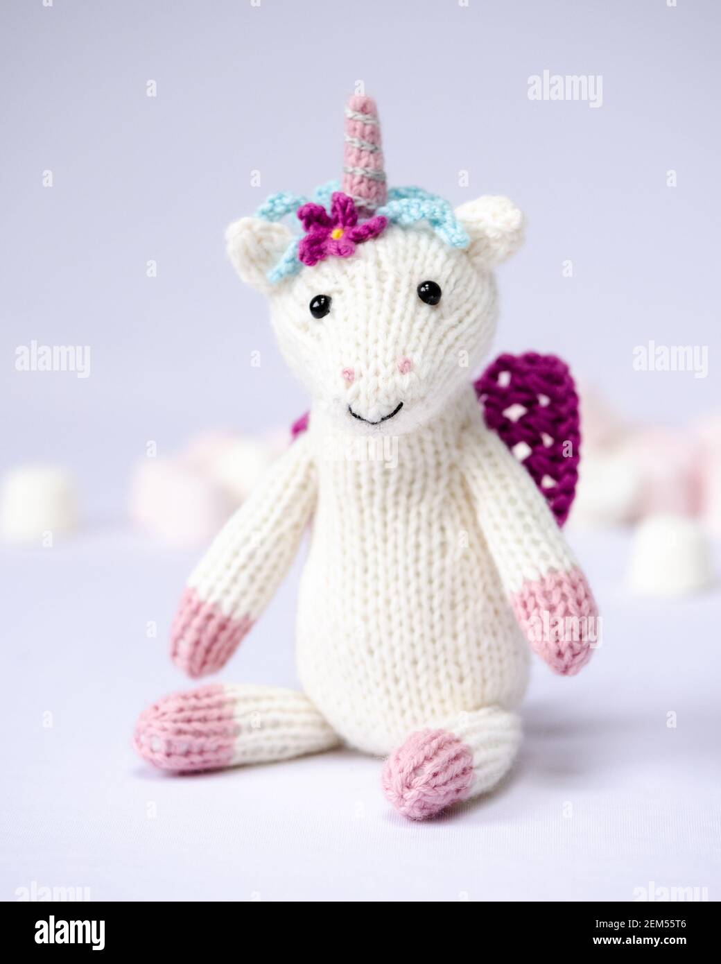 White woolen knitted unicorn figure with rose horn and feet created by ...