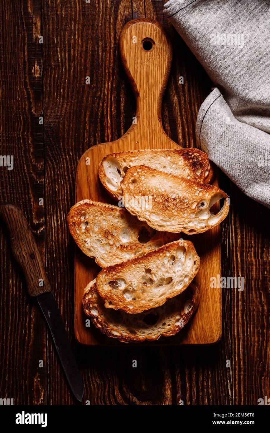Toasted bread on rustic wooden table, top view Stock Photo - Alamy