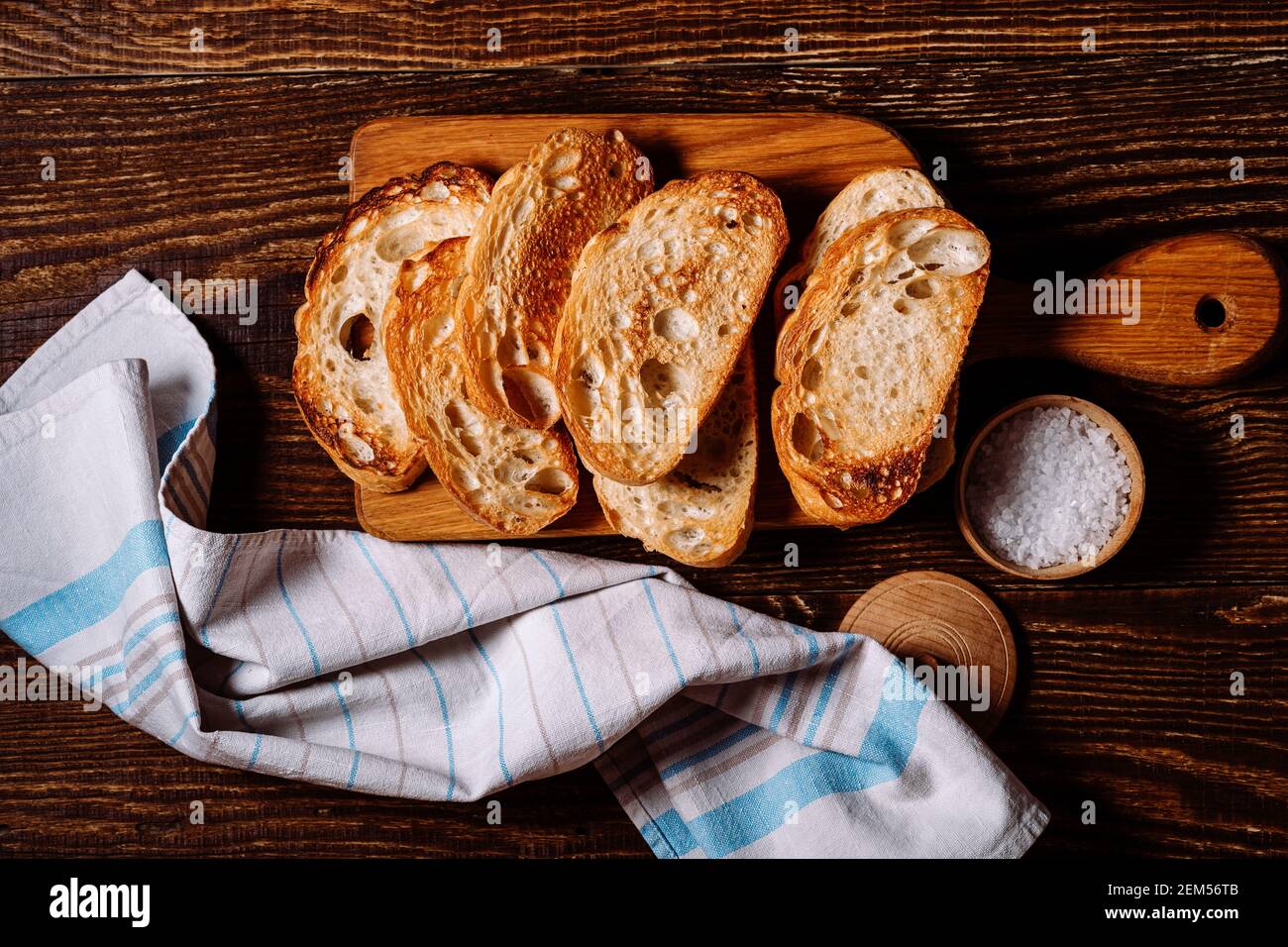 Toasted bread on rustic wooden table, top view Stock Photo - Alamy