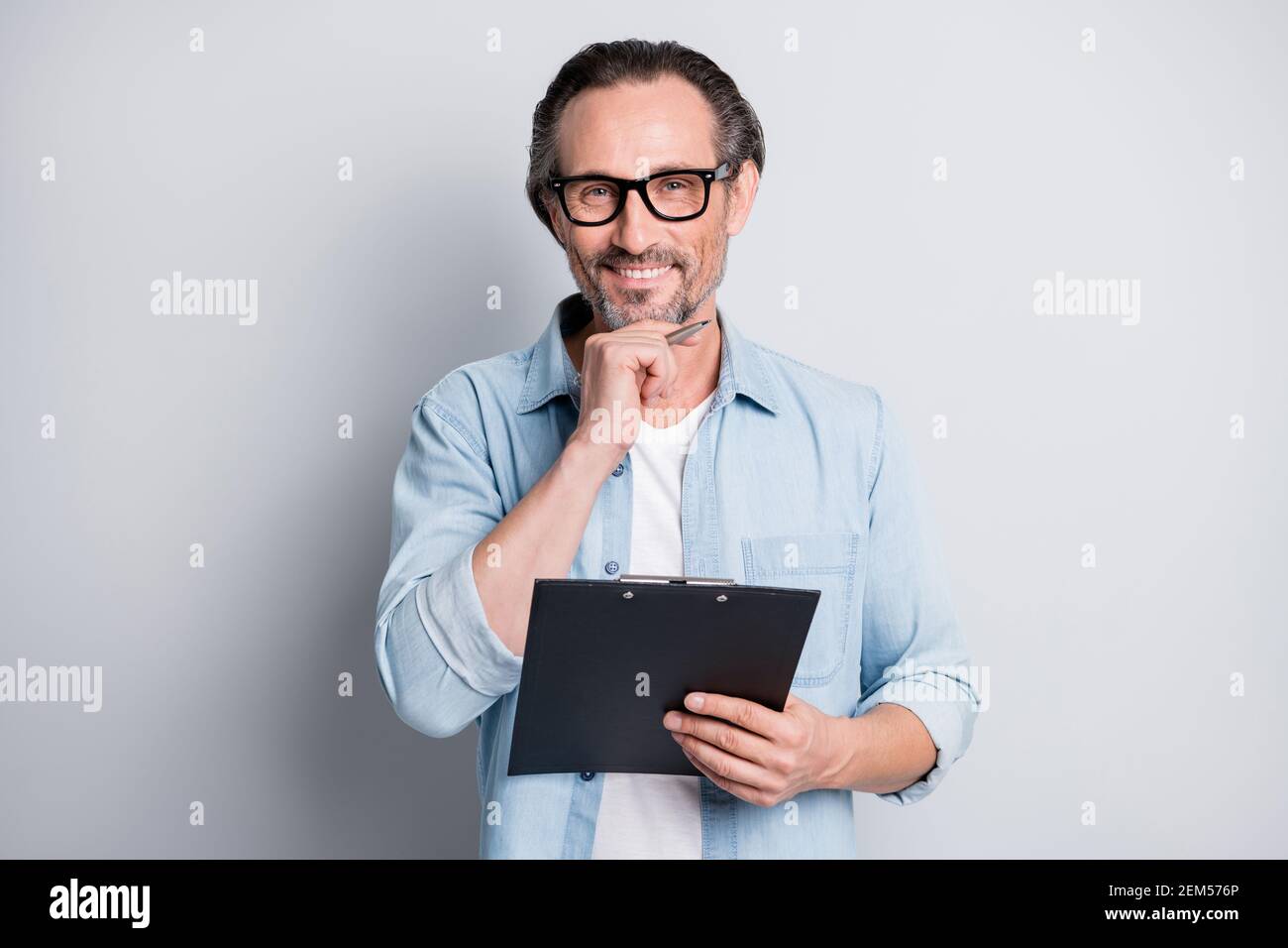Photo of handsome hr man happy positive smile think hold clipboard ...