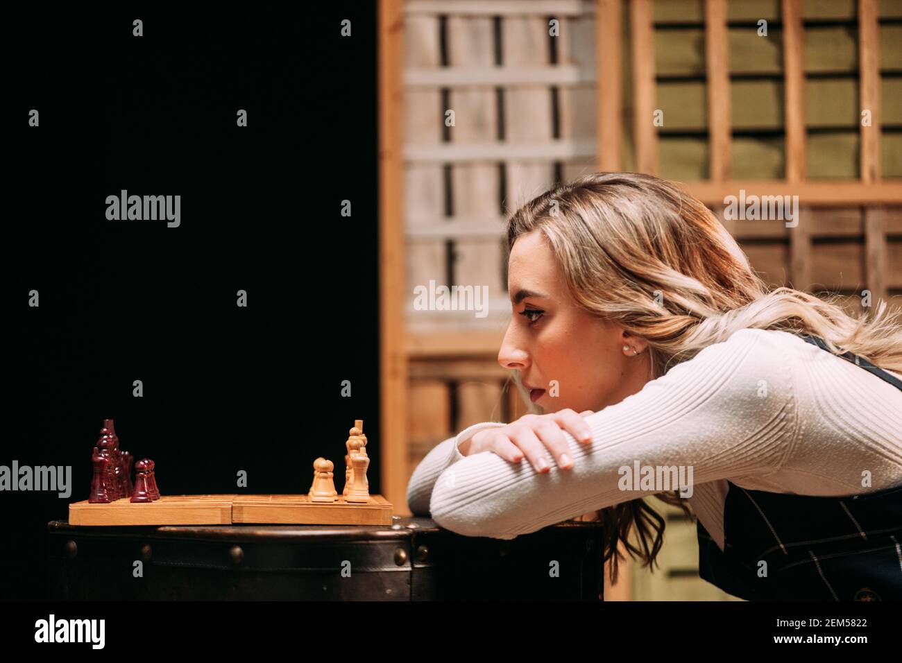 Competitive Girl Plays Chess Isolated In Black Background Stock Photo ...