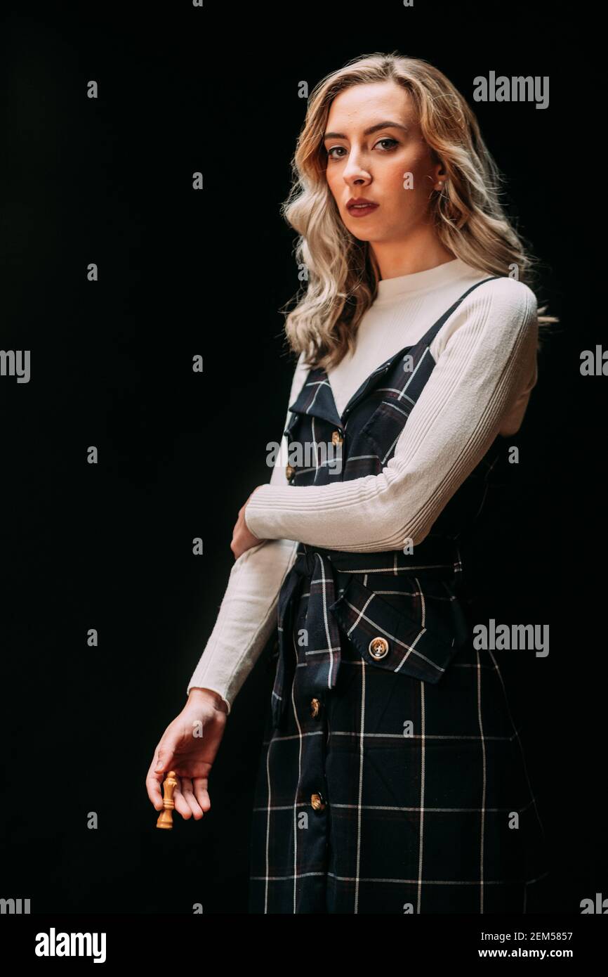Competitive Girl Plays Chess Isolated In Black Background Stock Photo ...