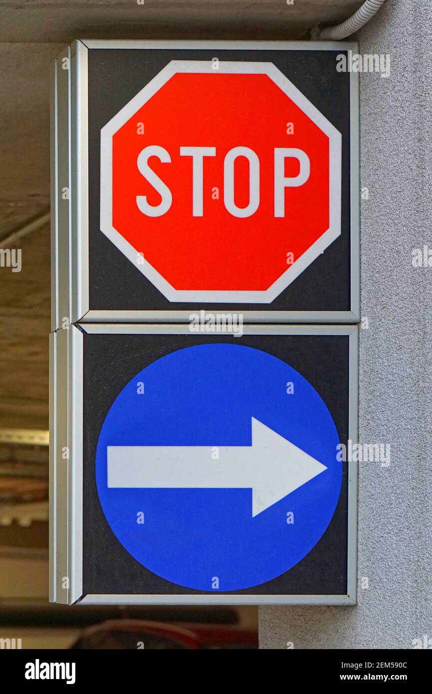 Stop sign and right direction arrow at garage entrance Stock Photo - Alamy