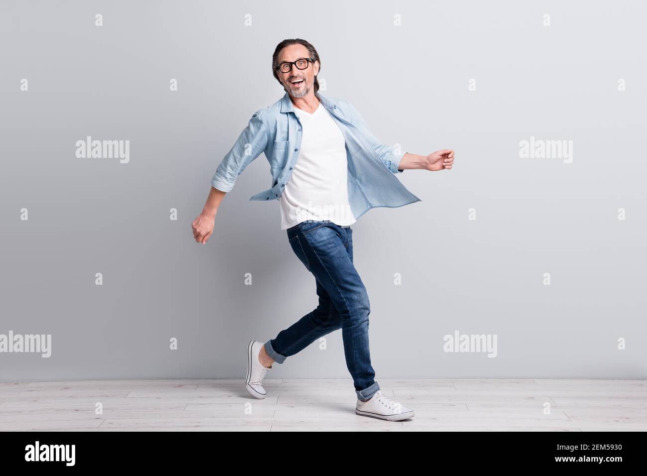 Full length photo of excited man happy positive smile go walk run ...