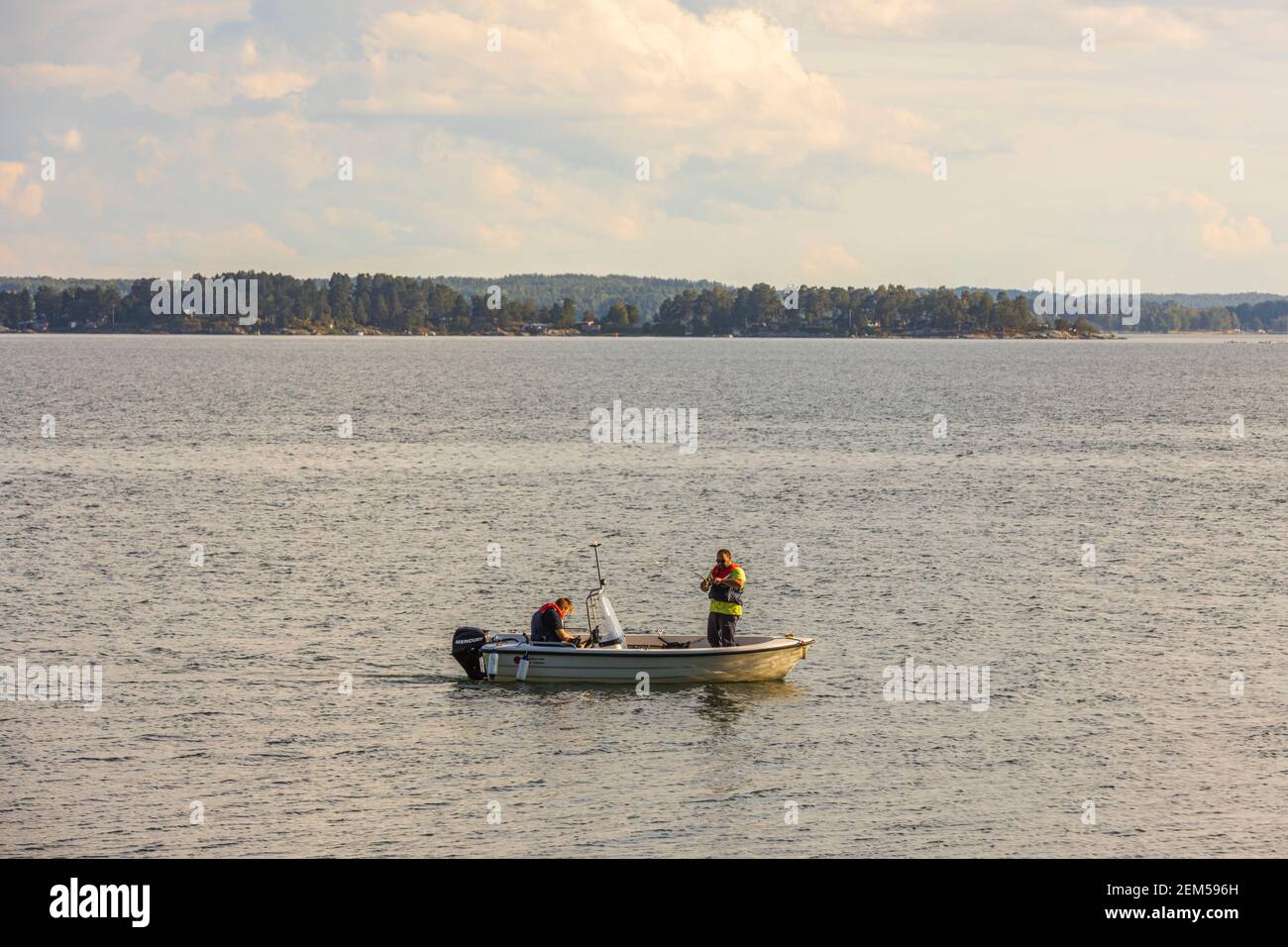 Beautiful Baltic sea landscape view. Men fishing from motorboat. Water ...