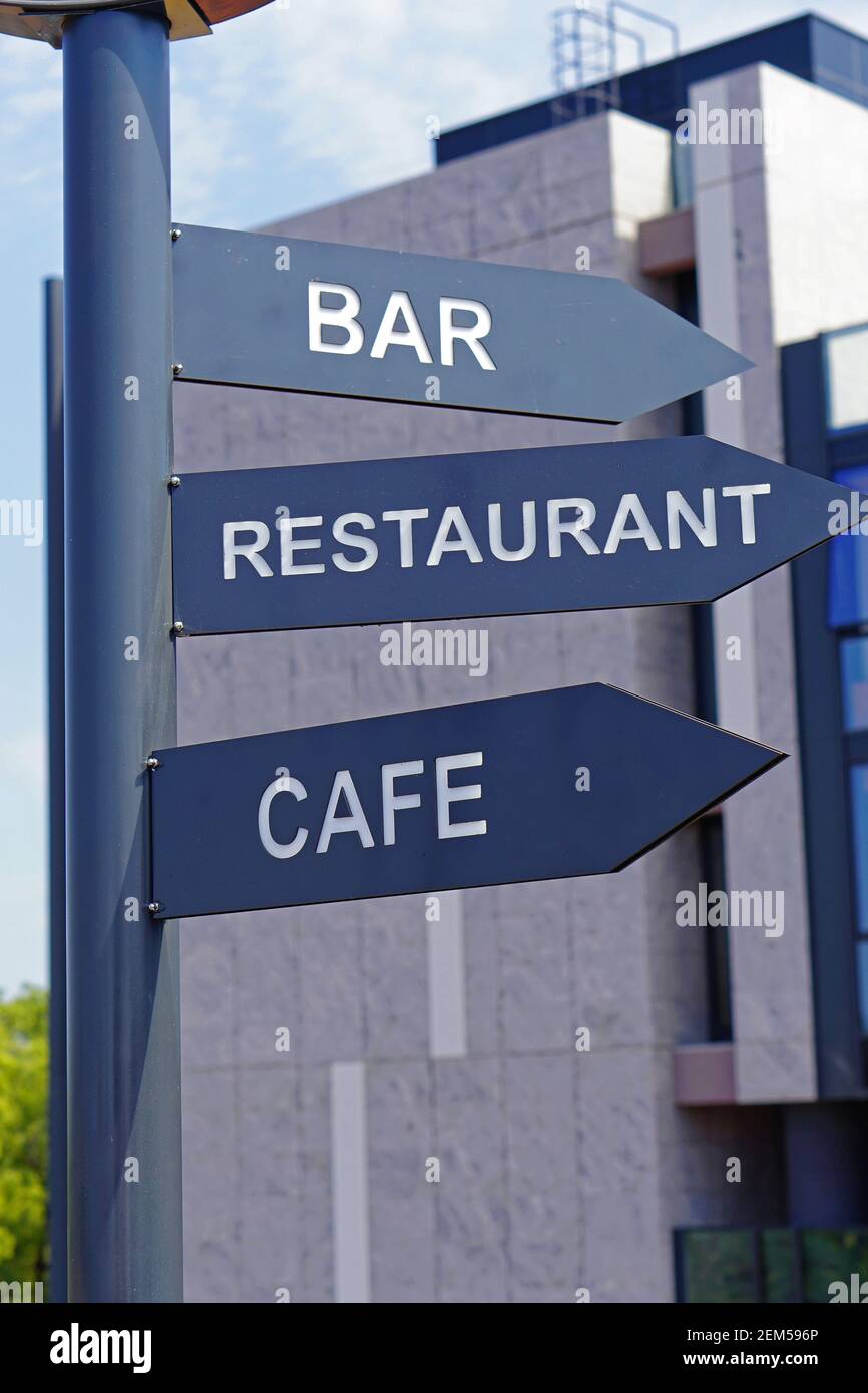 Black sign post for bar restaurant and cafe direction arrows Stock ...