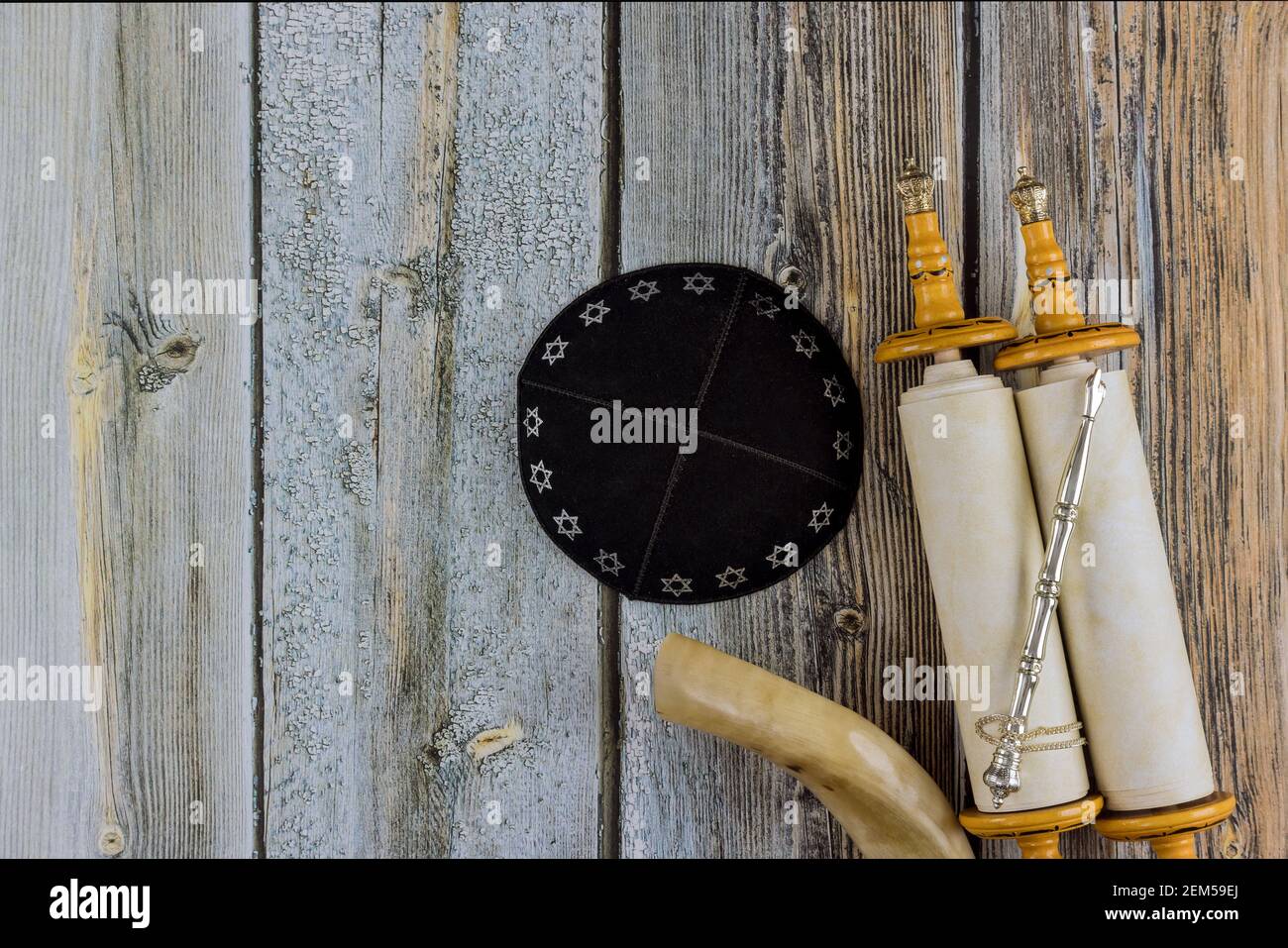 Jewish Orthodox prayer items kippa on shofar, torah scroll in a ...