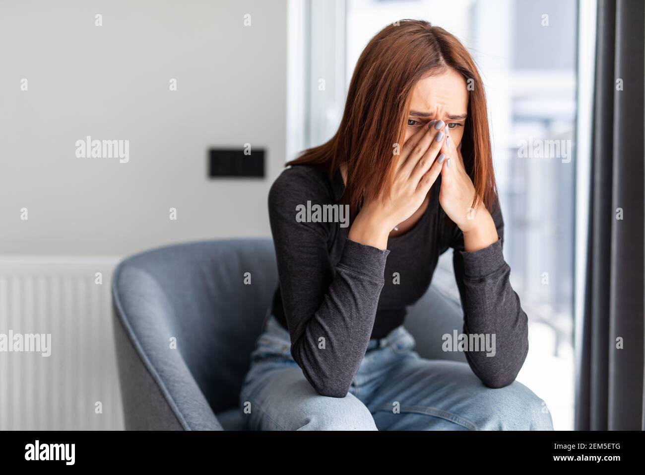 Woman suffering from depression sitting on a chair. bad mood and energy ...