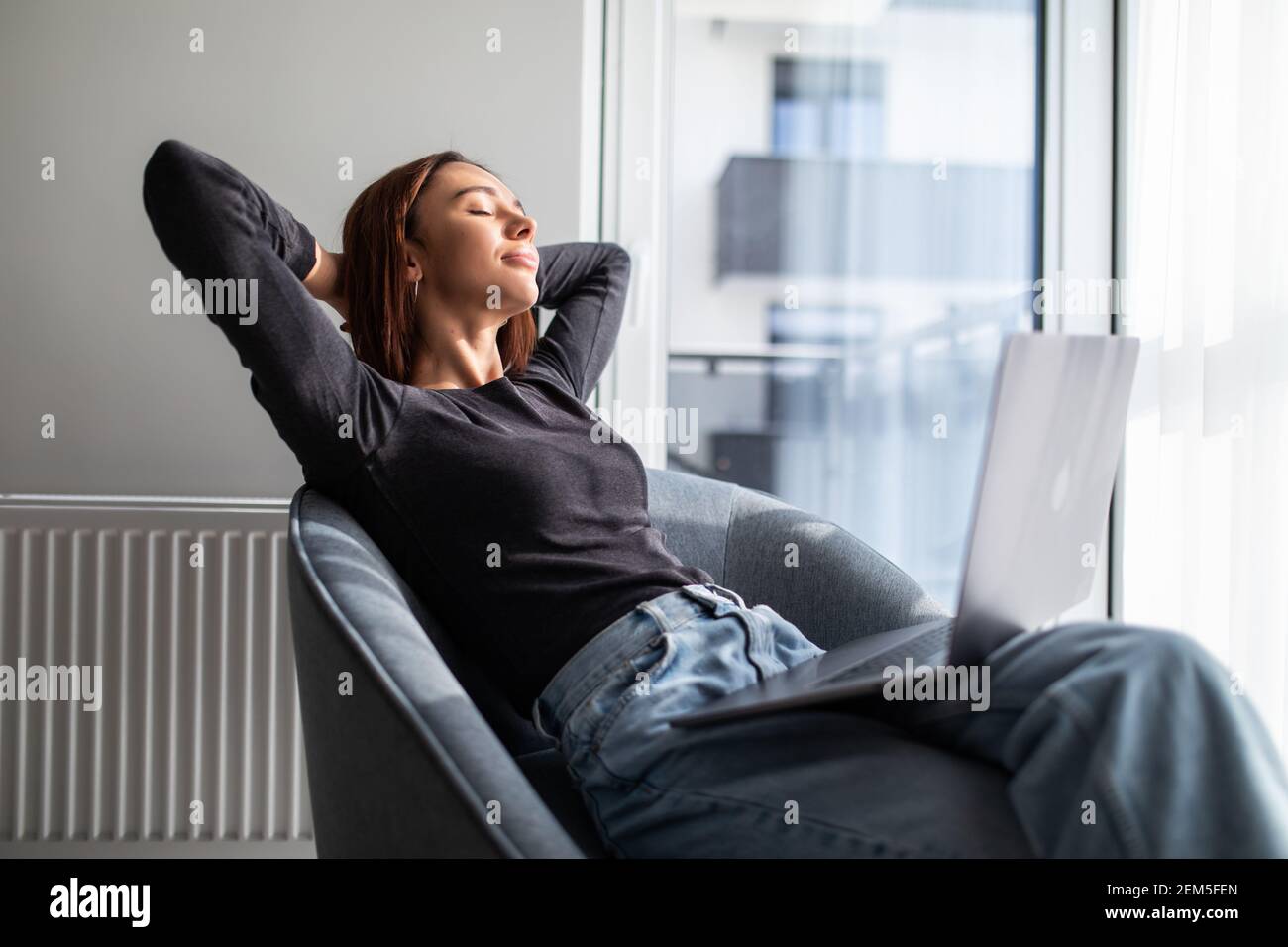 Woman sitting on rocking chair put hands behind head resting on lazy ...