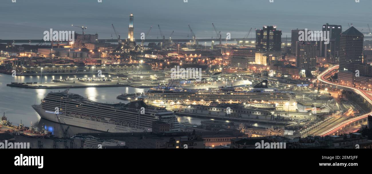 port of Genoa seen from above at night, with reflections on the sea ...