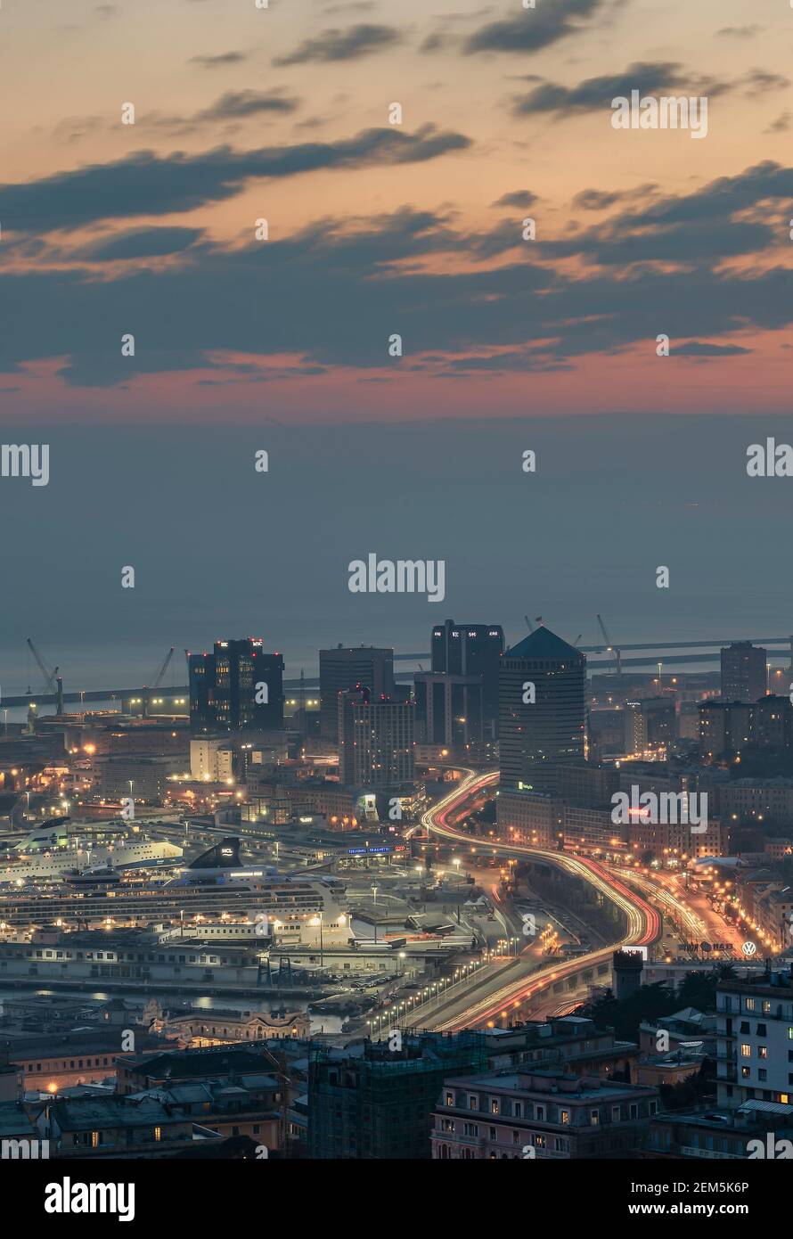 port of Genoa seen from above at night, with reflections on the sea ...