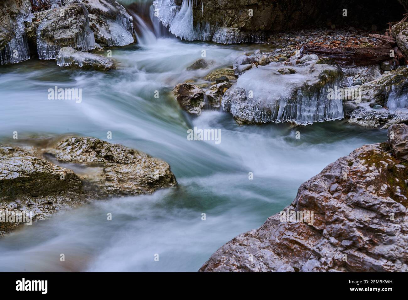 Icicles on a river flowing through a gorge in the winter Stock Photo ...