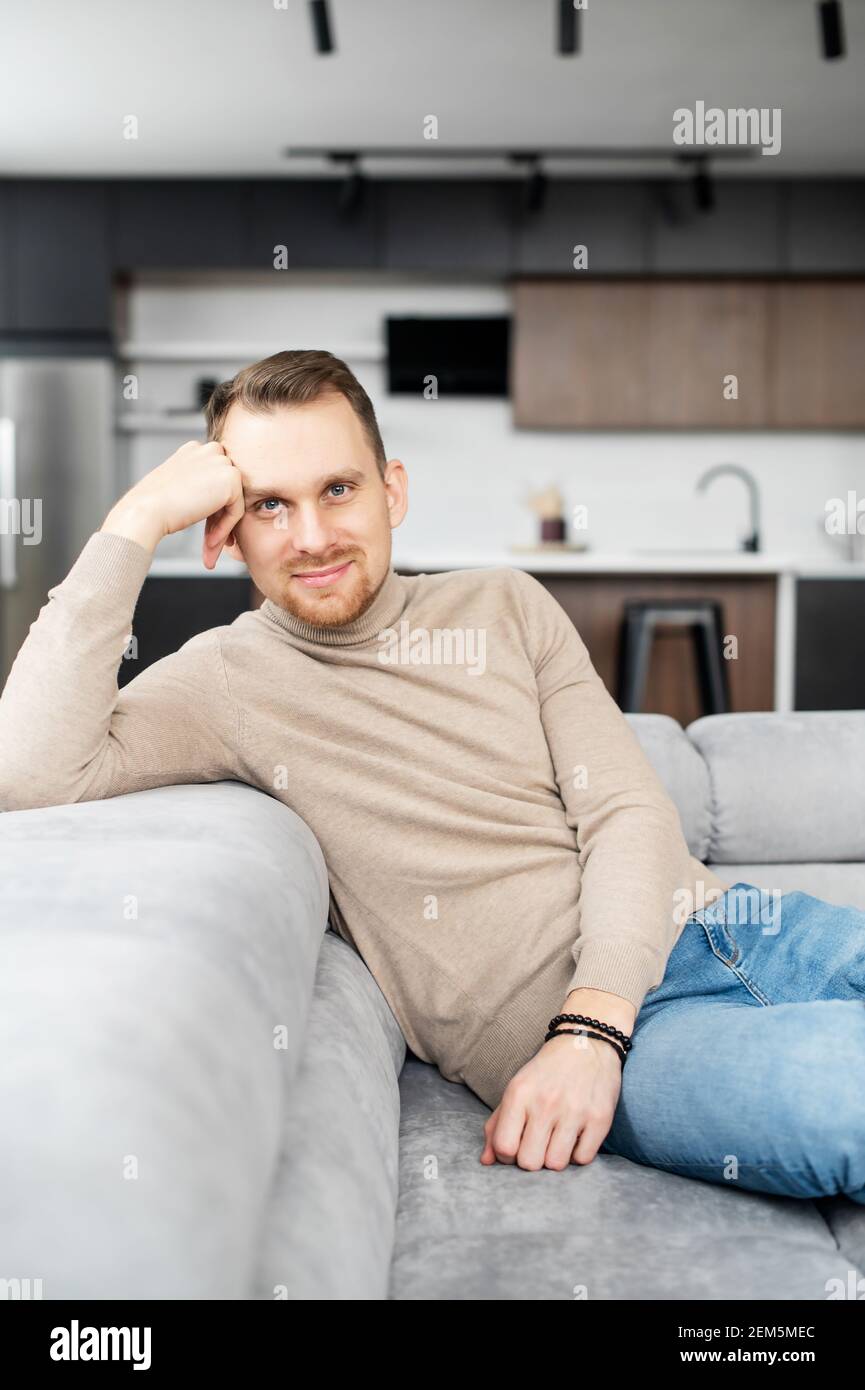Confident and slender man with light brown hair, grey eyes and short ...