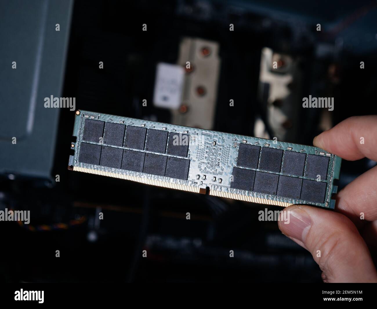 Male hand holding computer RAM random access memory with computer ...