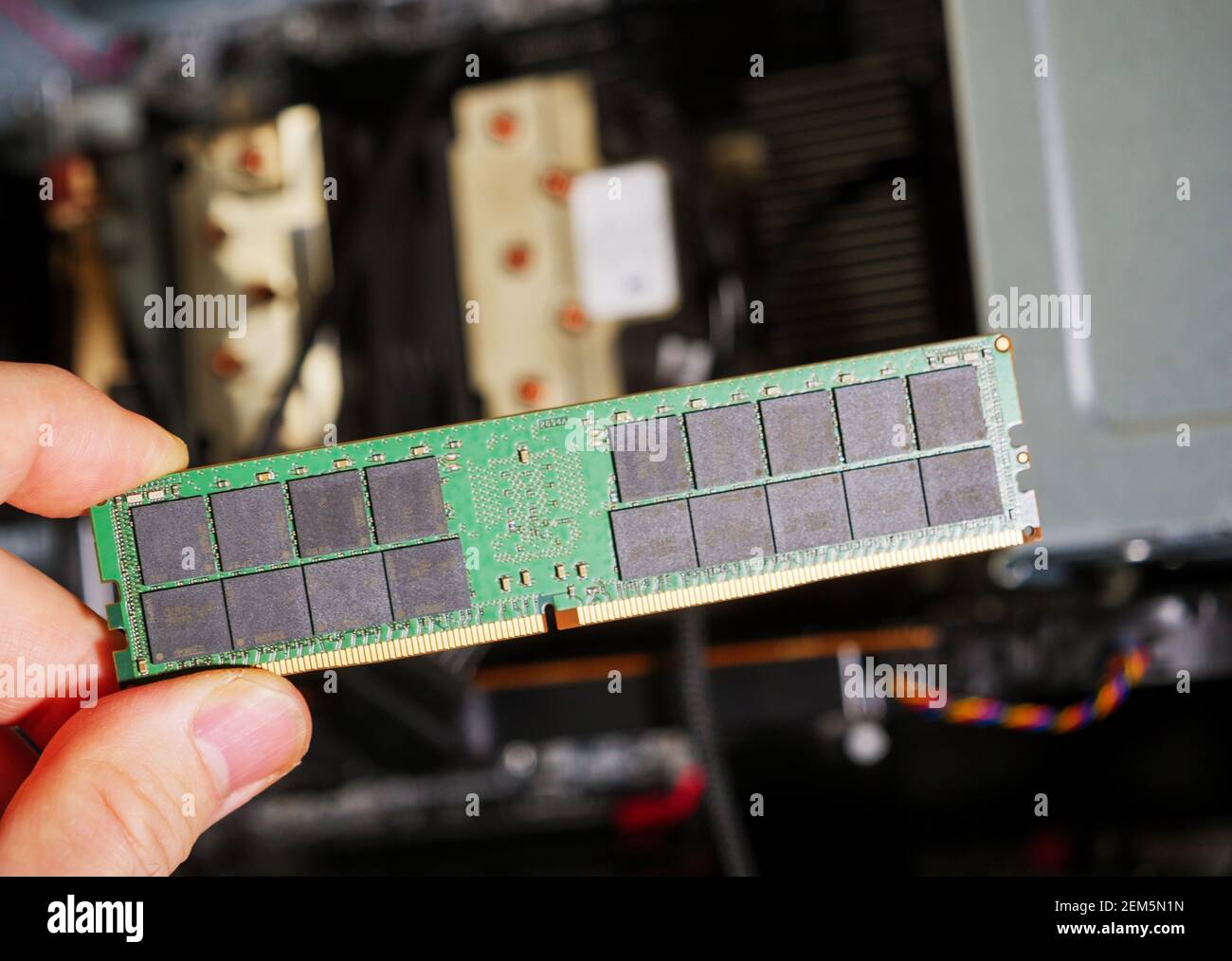 Male hand holding computer RAM DDR4 random access memory with computer ...