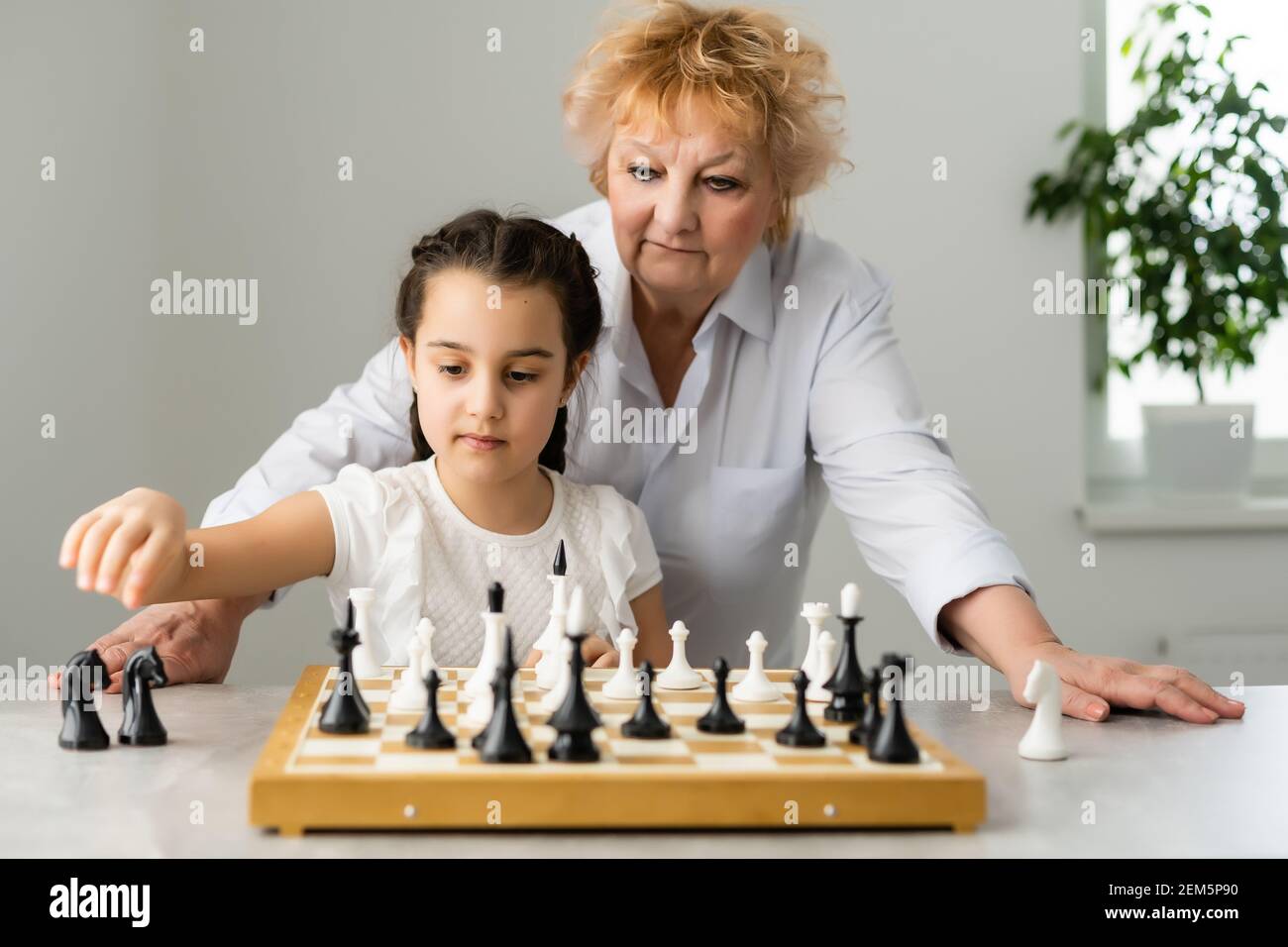 Old lady playing chess hi-res stock photography and images - Alamy