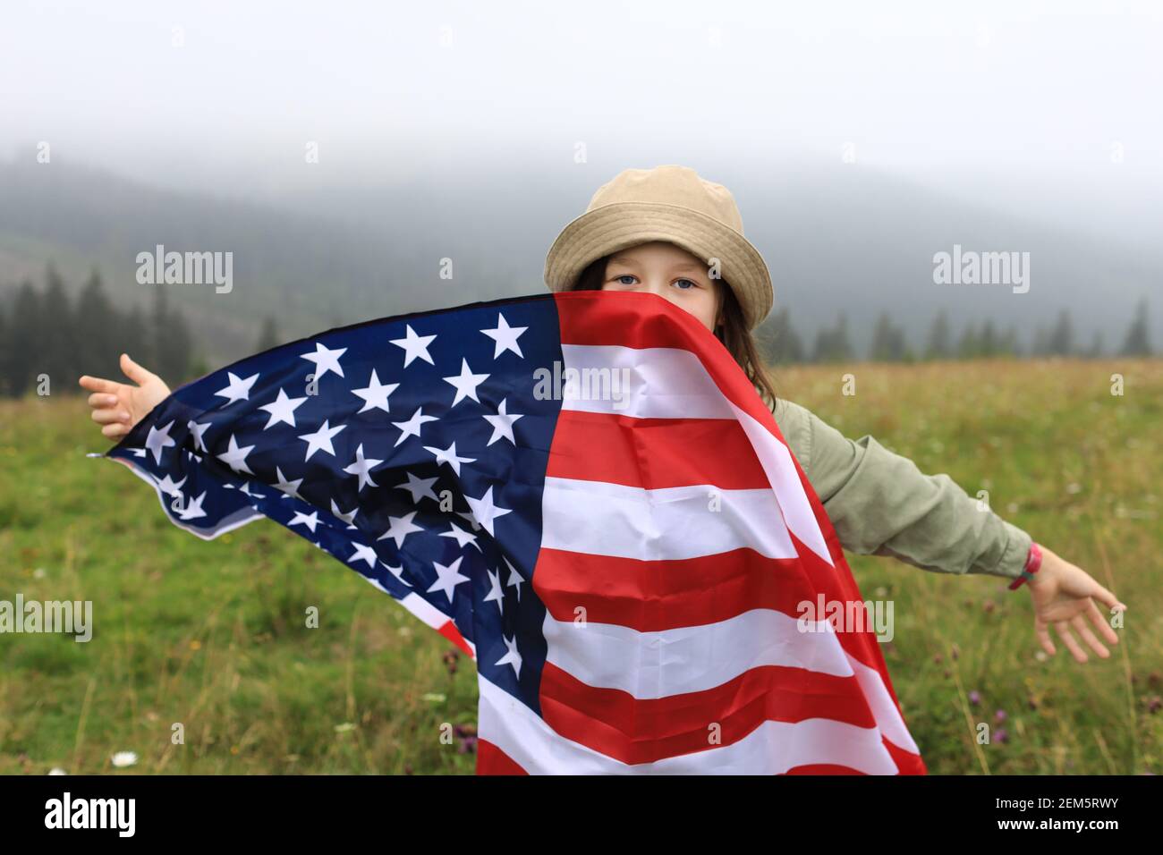 Happy adorable little girl smiling and waving American flag. Patriotic ...