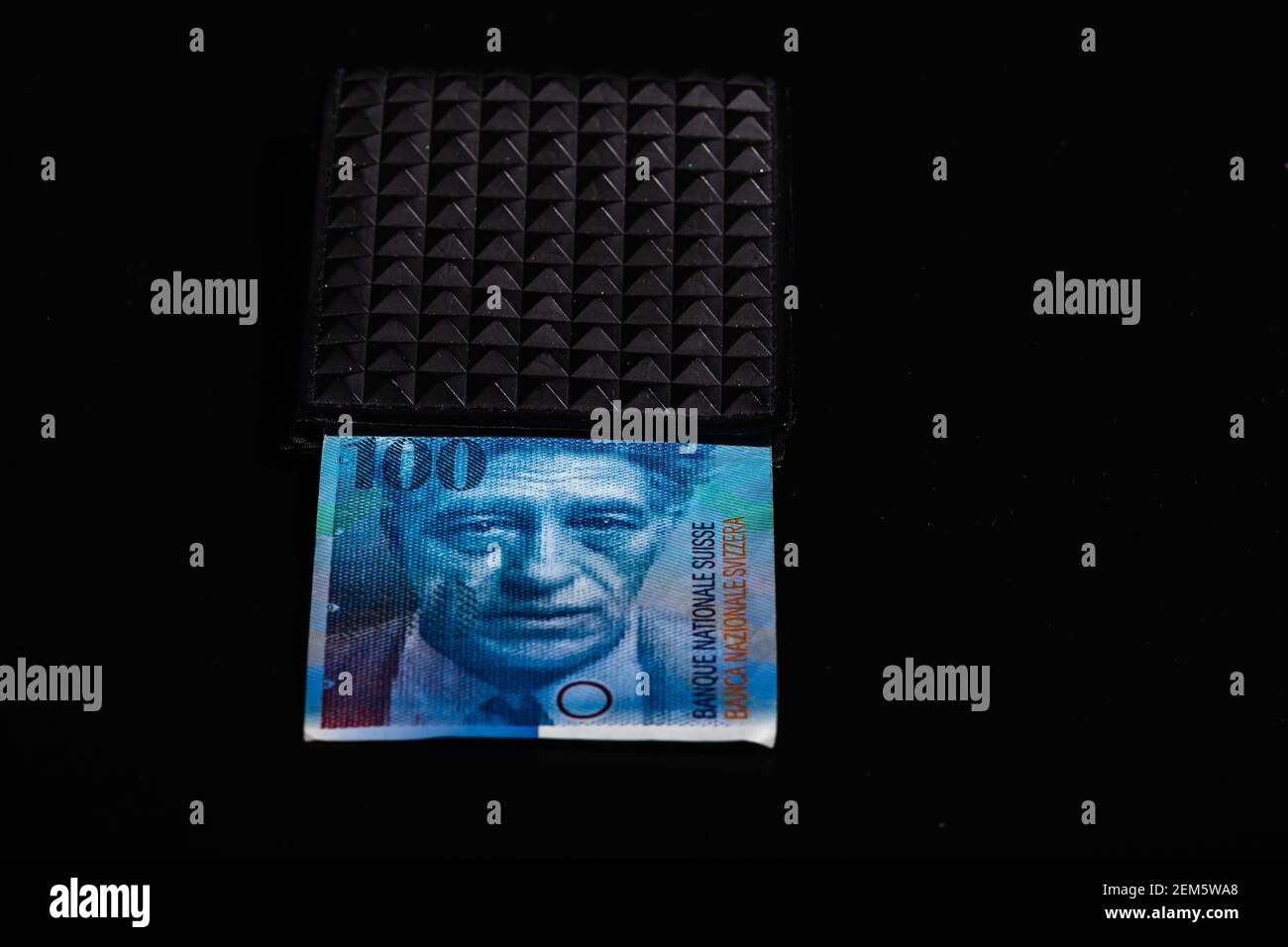 100 swiss franc banknote in a black wallet isolated Stock Photo - Alamy