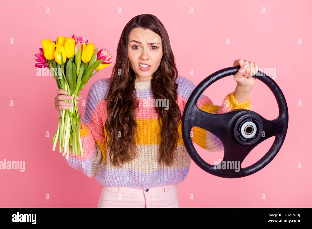 Portrait of pretty worried nervous girl delivering bunch tulips driving ...