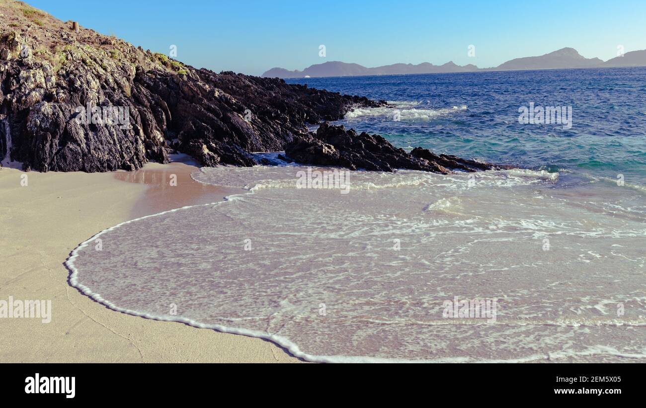 beach without people with sea water forming curves and mountains in the ...