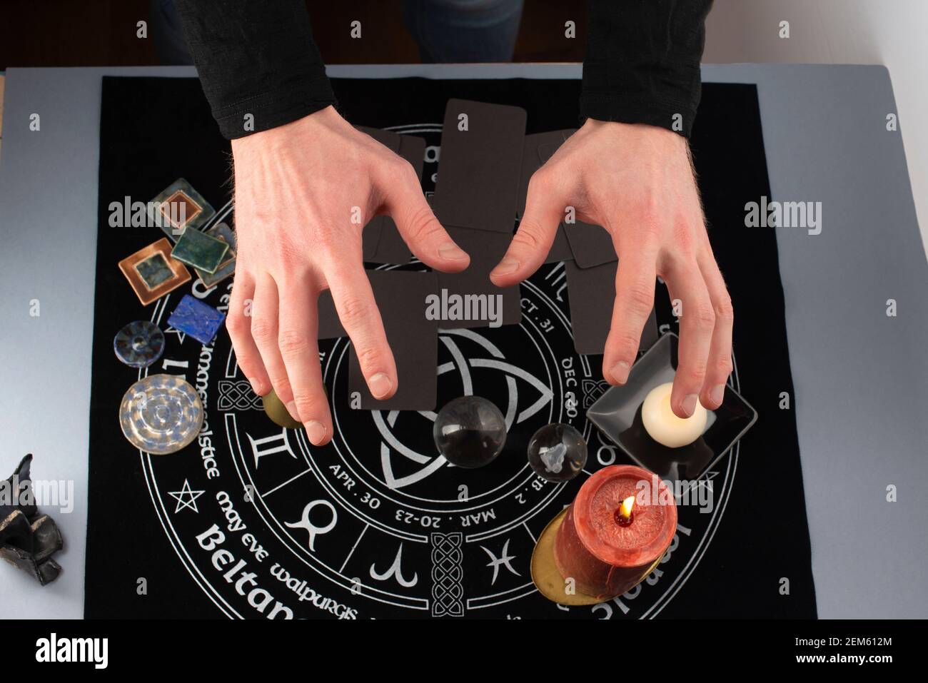 Man's hands over the table with occult and magic objects. Esoteric ...