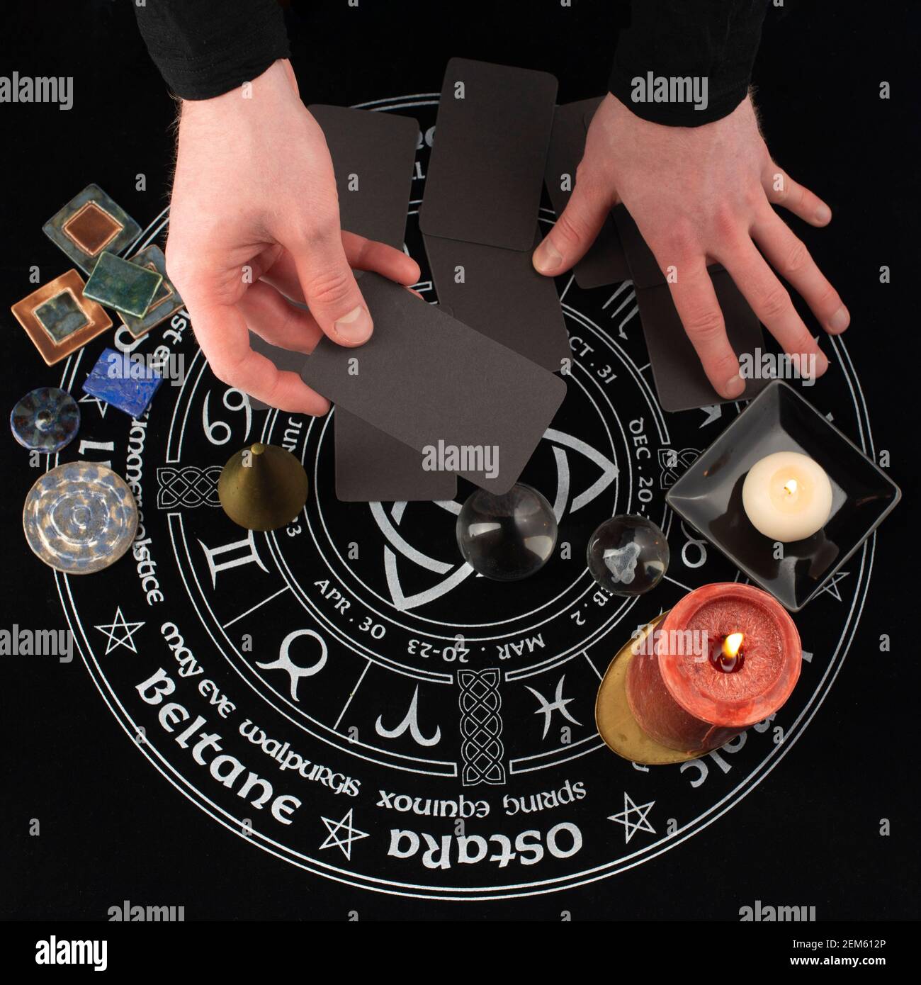 Hand holding blank card in front of mystic background with occult and ...