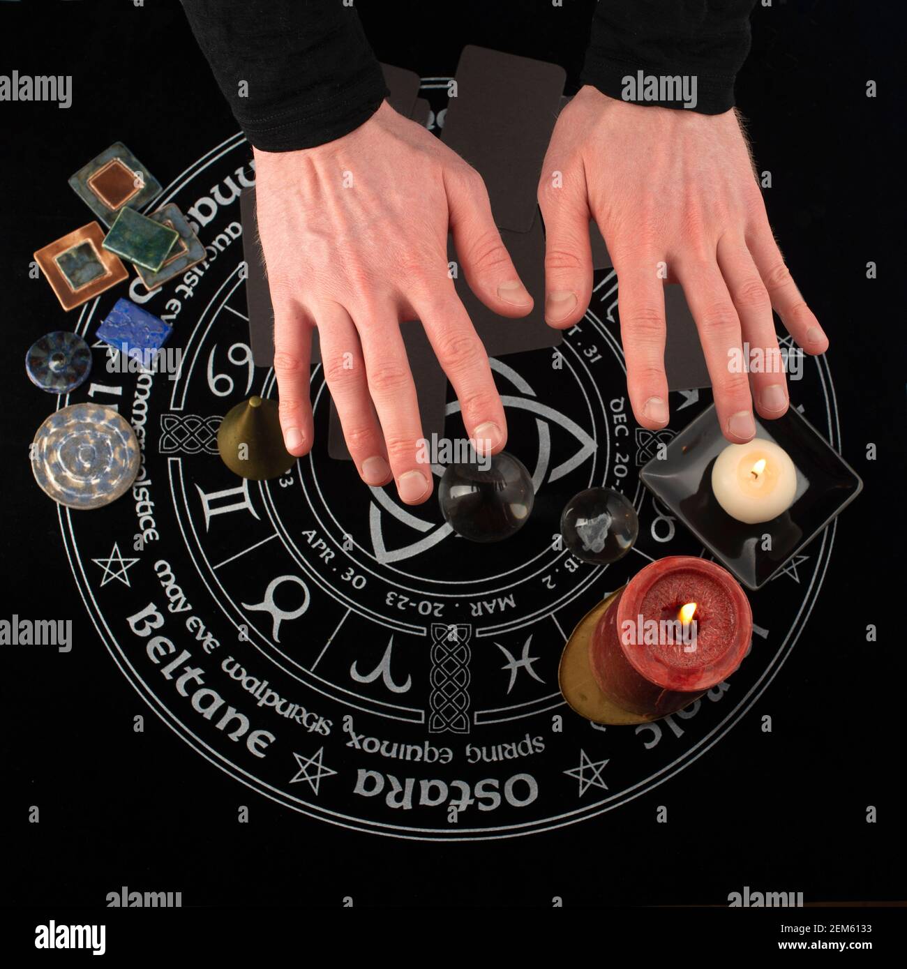 Man's hands over the table with occult and magic objects. Esoteric ...