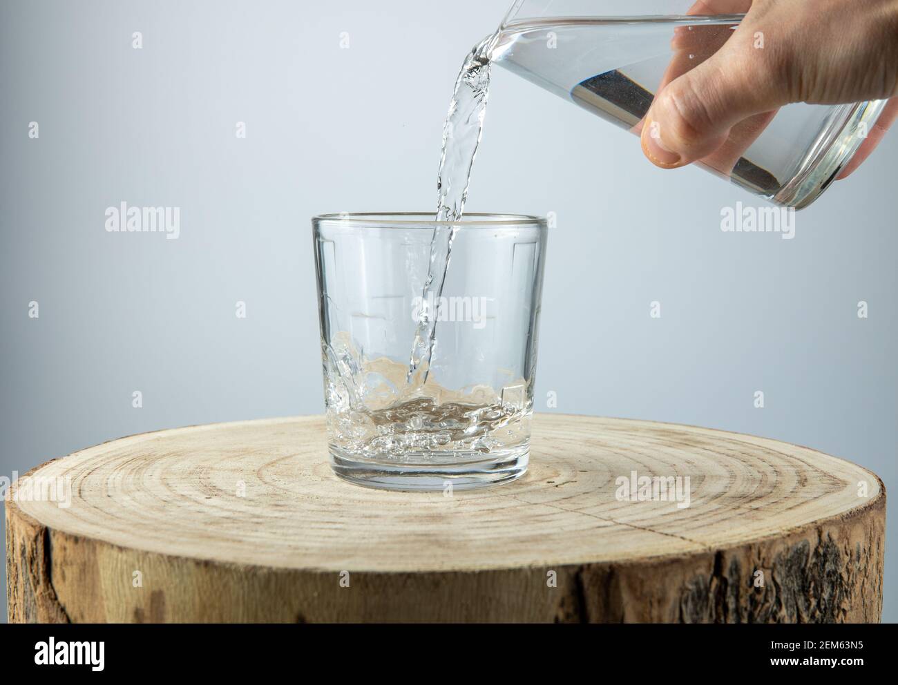 water pouring into glass on white background Stock Photo - Alamy