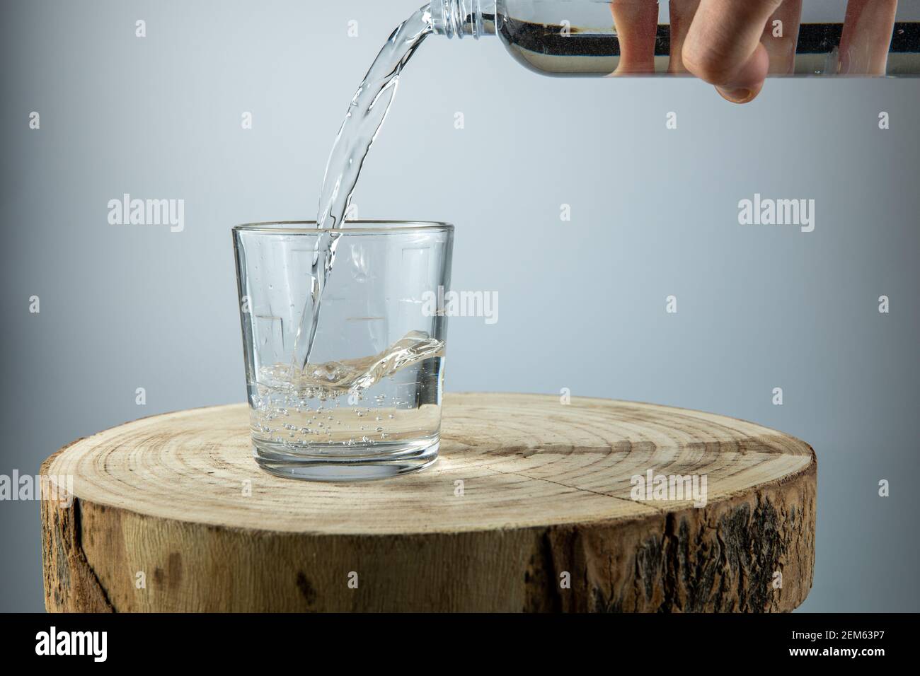 water pouring into glass on white background Stock Photo - Alamy