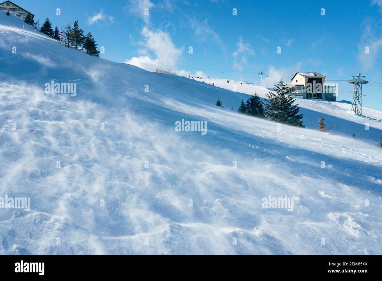 Blowing snow over snowy surface on top of mountain in Switzerland ...