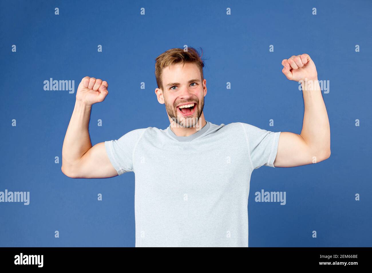 Strong and full of energy. Man strong handsome unshaven guy on violet ...