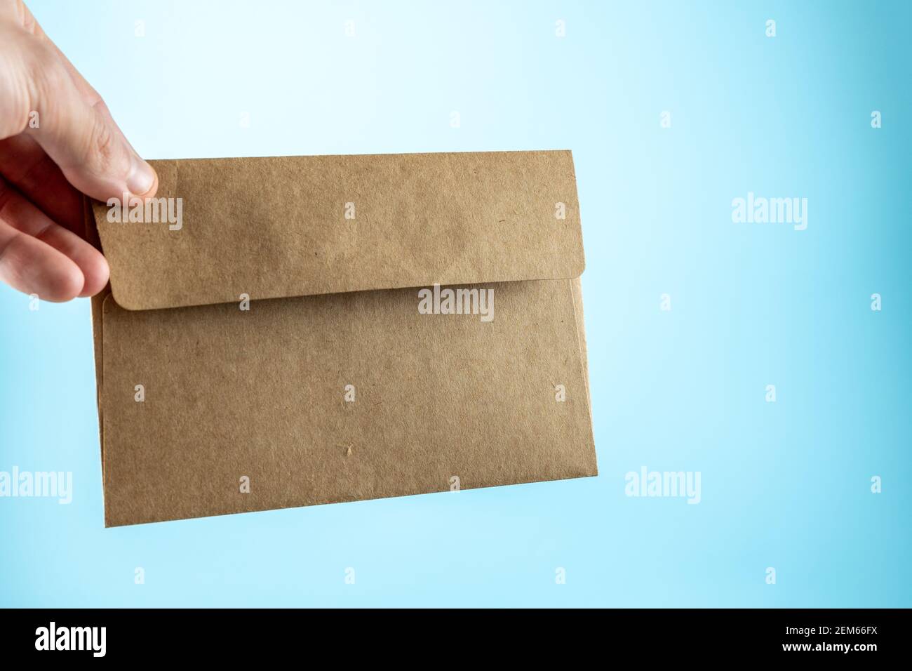 Envelope on blue background copy space Stock Photo - Alamy