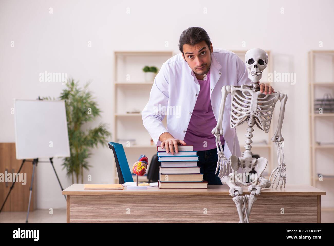 Young doctor student studying human skeleton in the classroom Stock ...