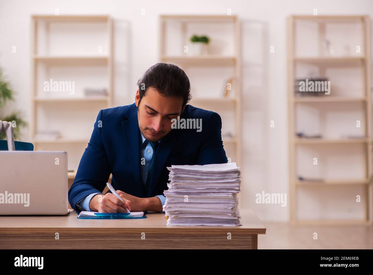 Dead employee working in the office in funny concept Stock Photo - Alamy