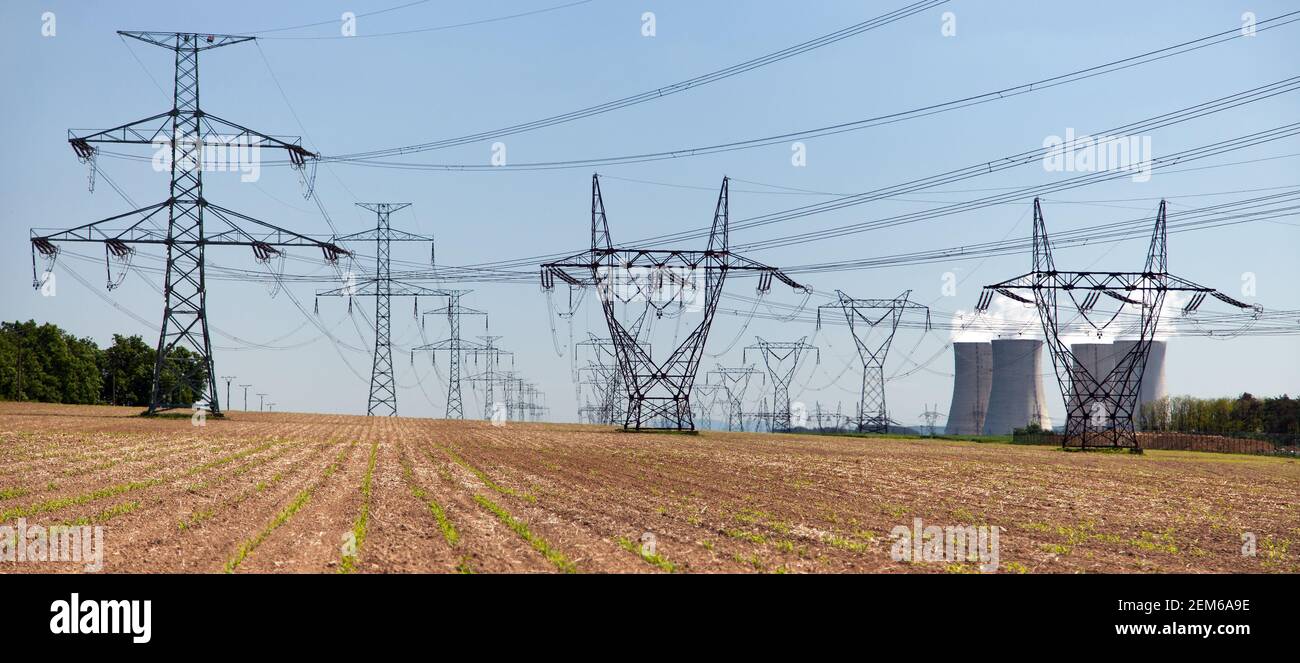 Line of high voltage electricity and nuclear power plant cooling towers ...