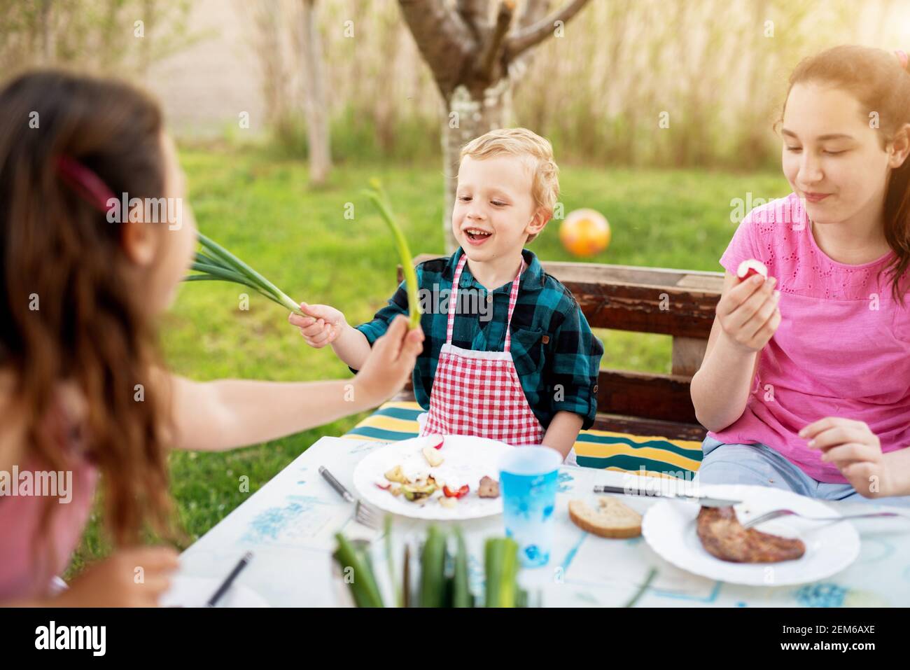 Family kids sitting around table hi-res stock photography and images ...