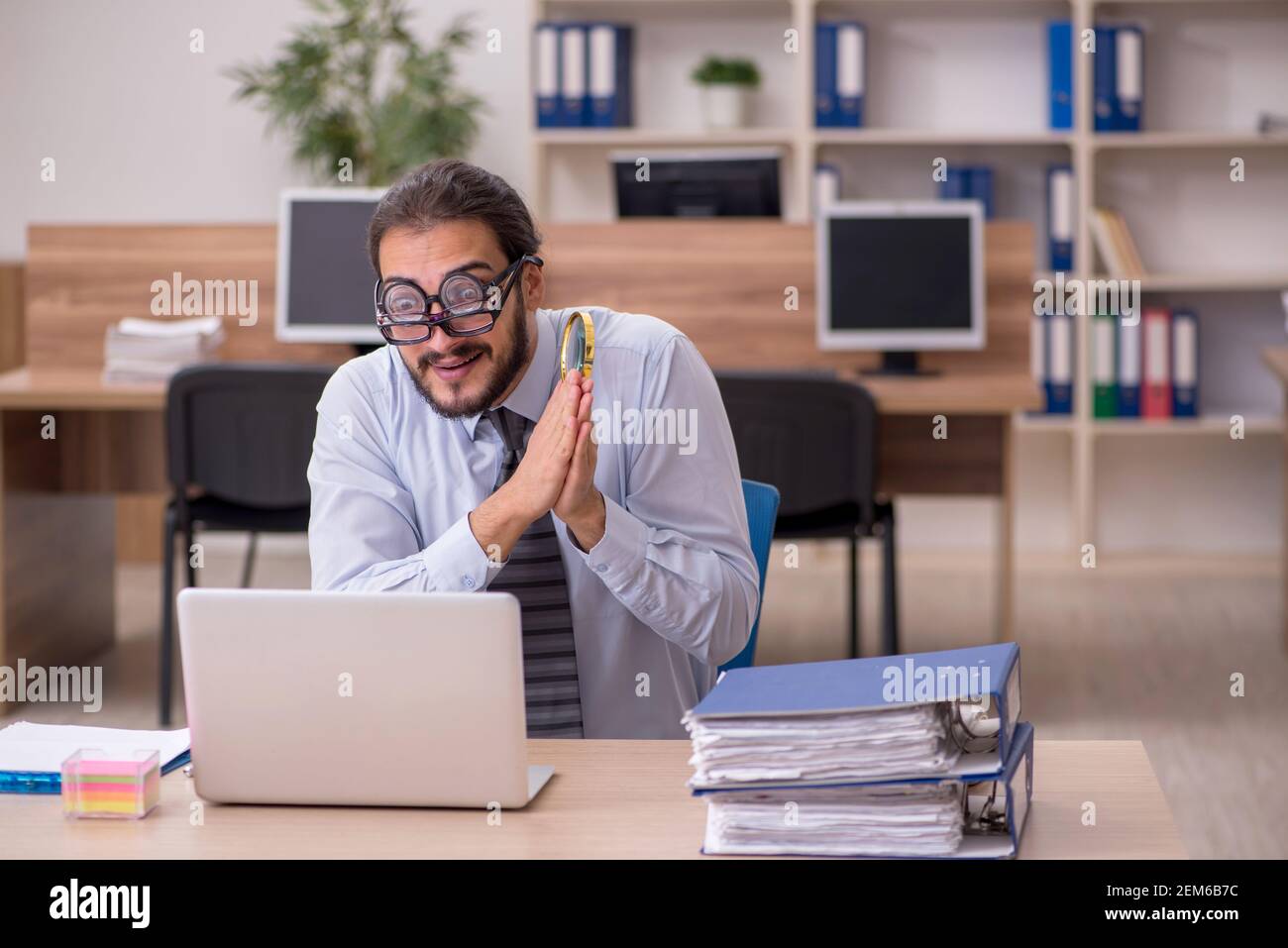 Office work funny young magnifying hi-res stock photography and images - Alamy
