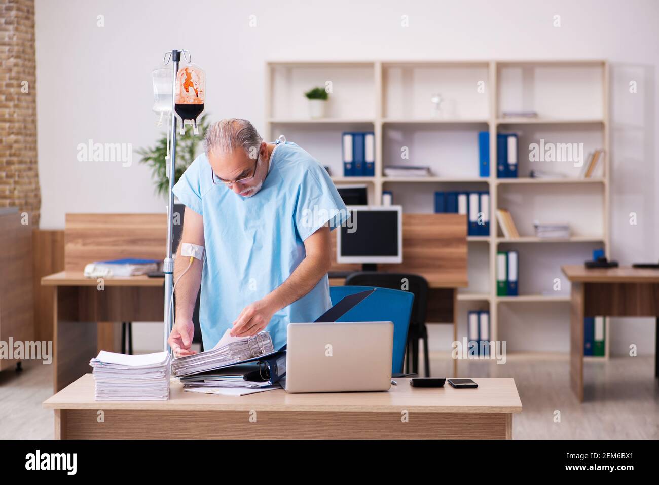 Old businessman employee in blood transfusion concept Stock Photo - Alamy
