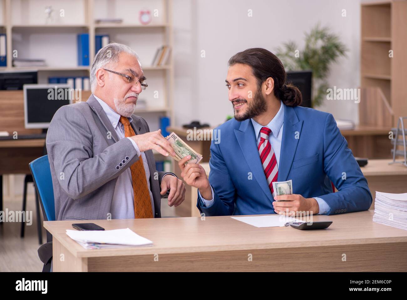 Two employees in remuneration concept Stock Photo - Alamy