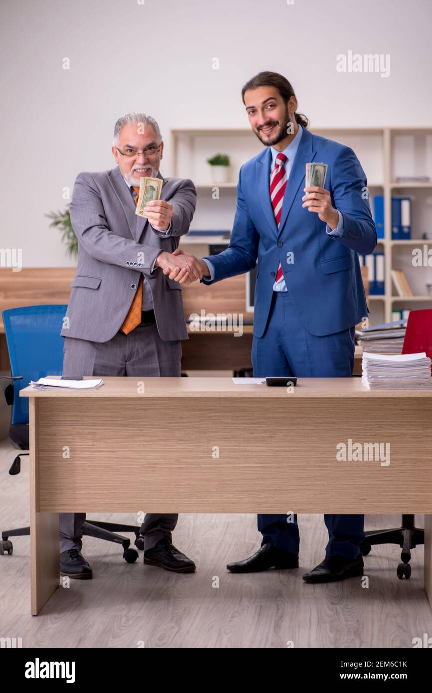 Two employees in remuneration concept Stock Photo - Alamy
