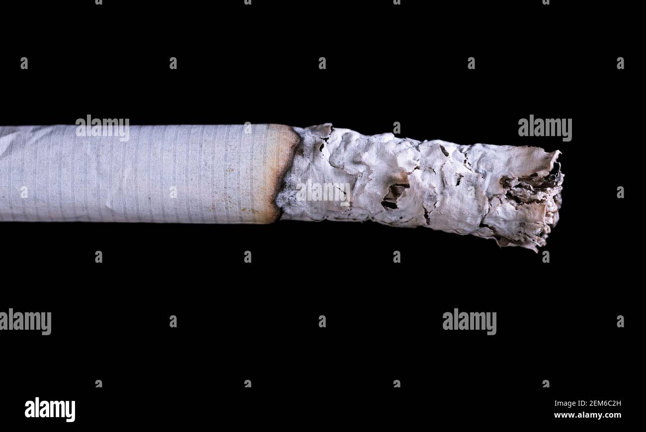 Burning Cigarette with Smoke in a black background Stock Photo - Alamy