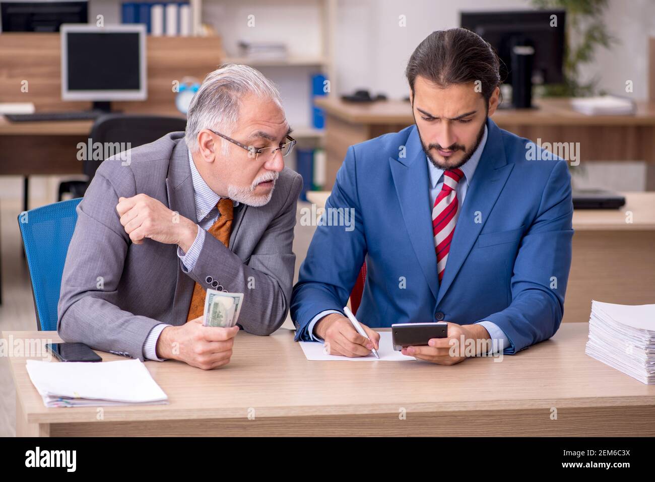 Two employees in remuneration concept Stock Photo - Alamy