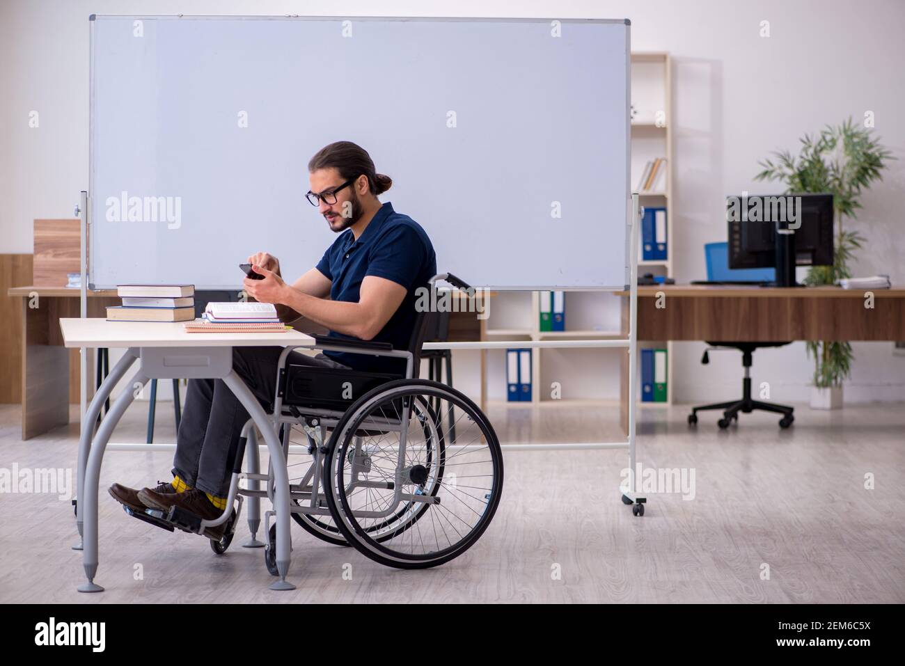Young handicapped student in the classroom Stock Photo - Alamy