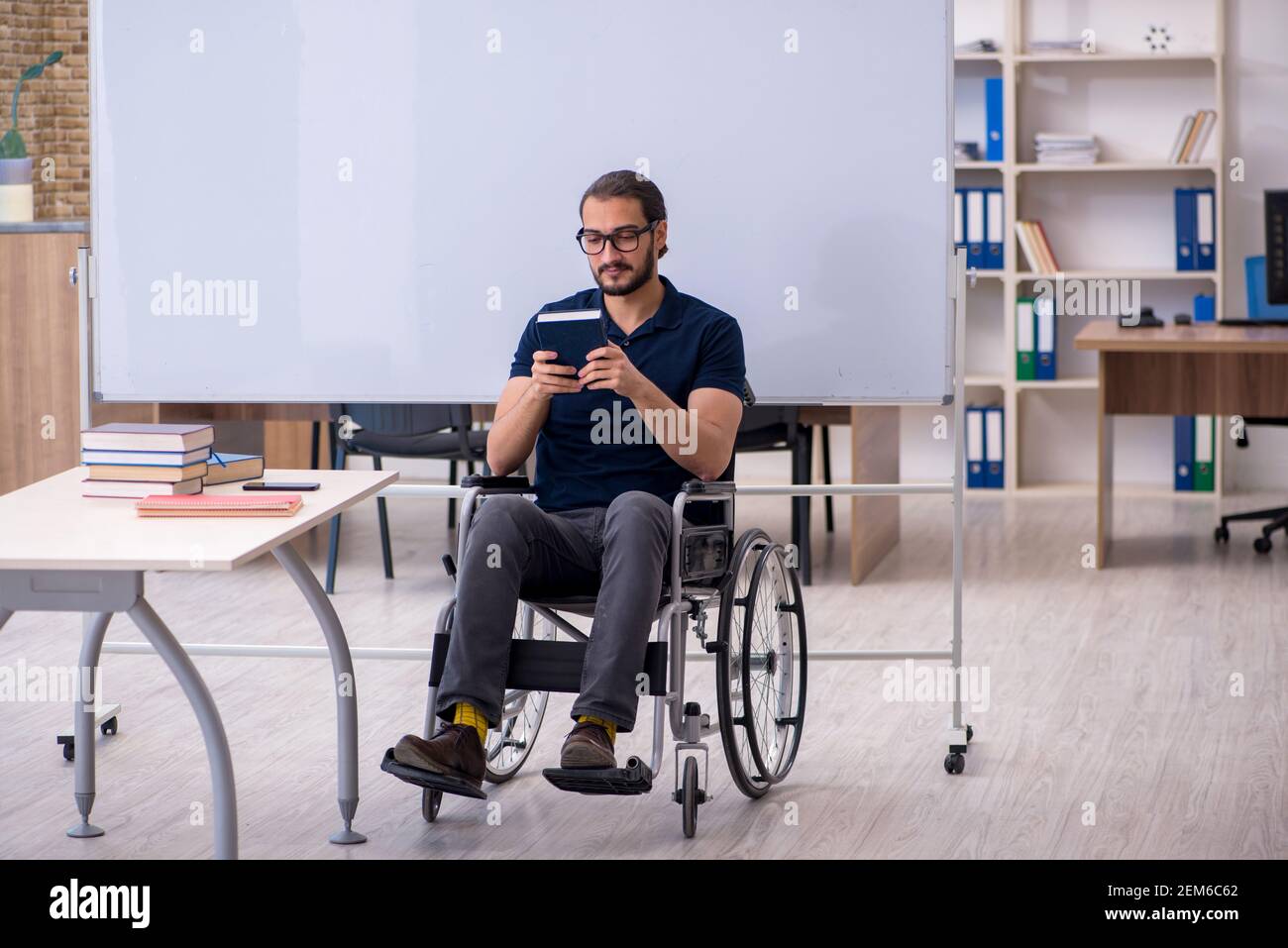Young handicapped student in the classroom Stock Photo - Alamy