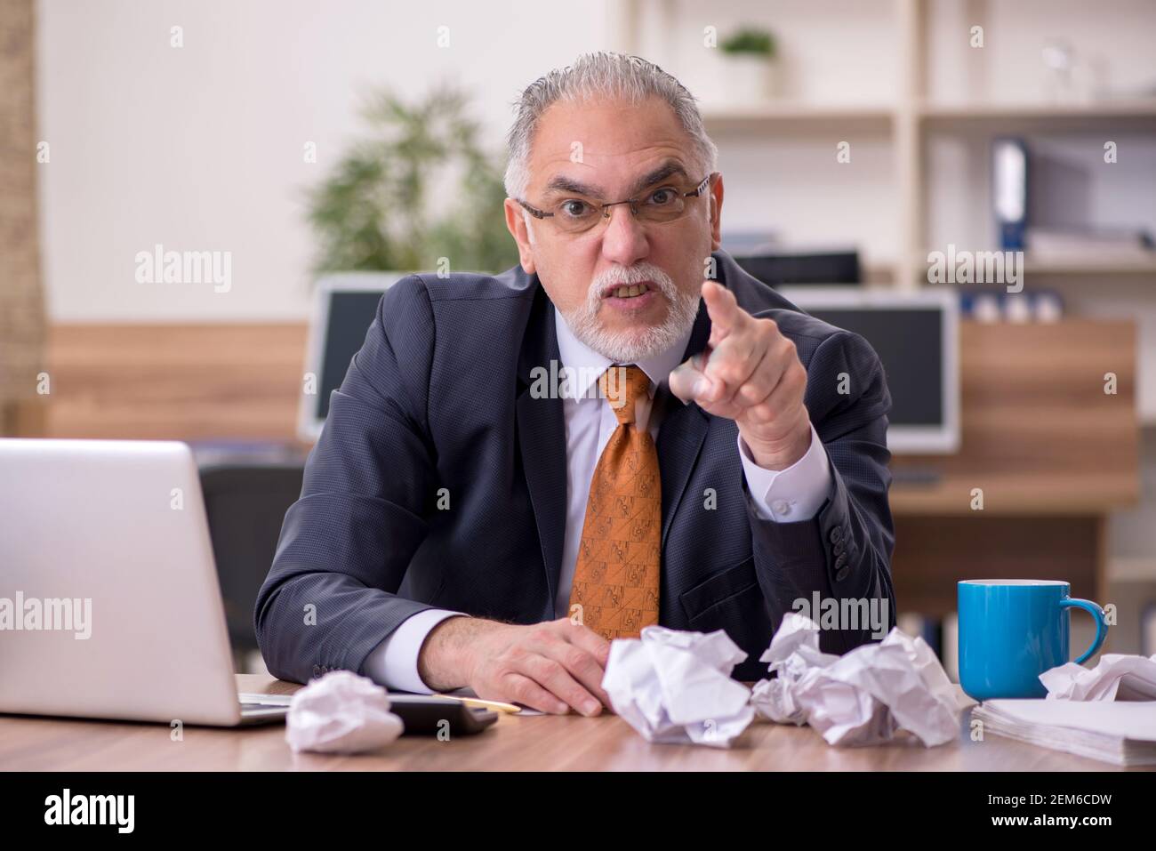 Old employee in paper recycling concept Stock Photo - Alamy