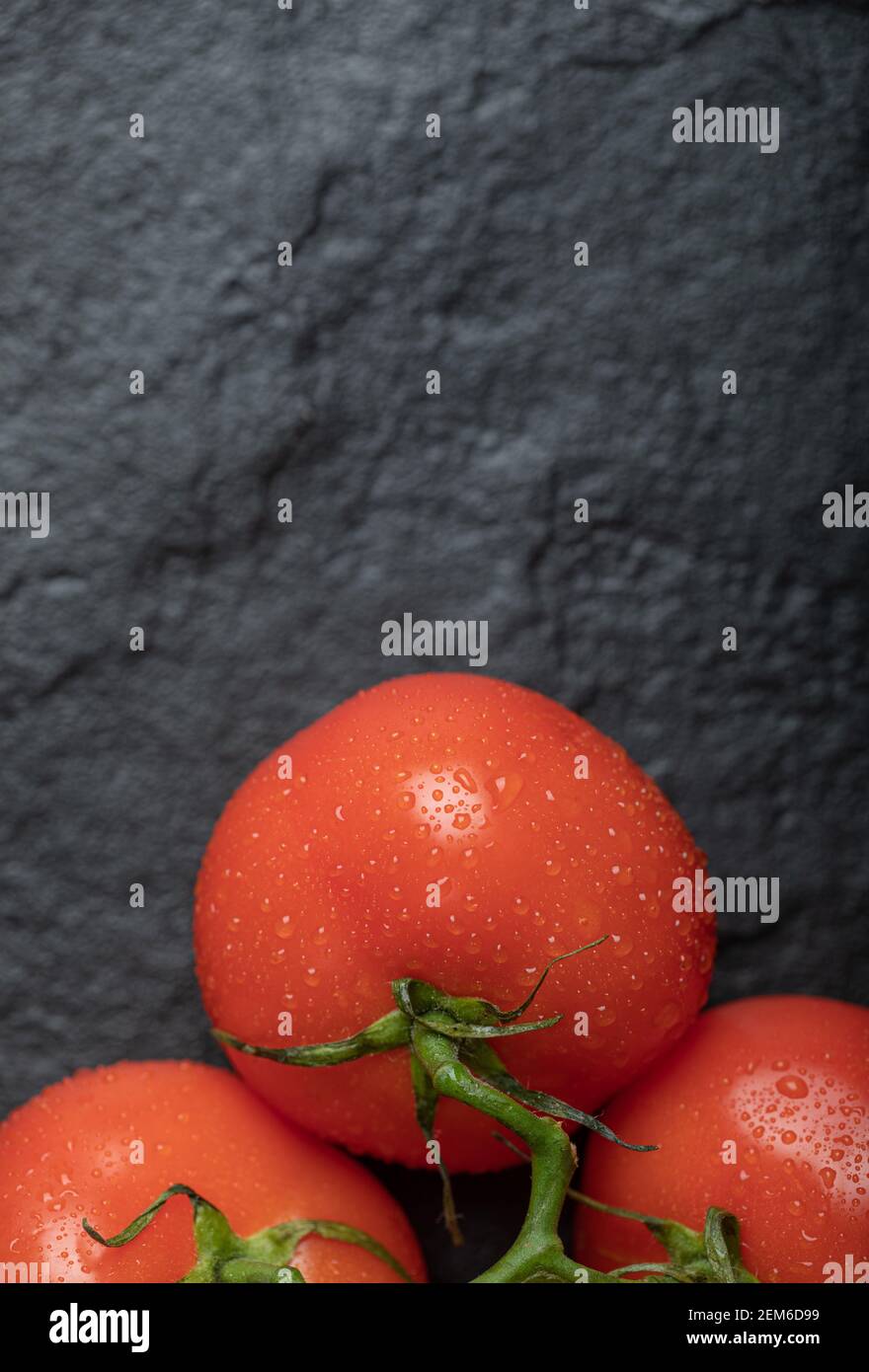 Fresh red tomatoes on dark background Stock Photo - Alamy