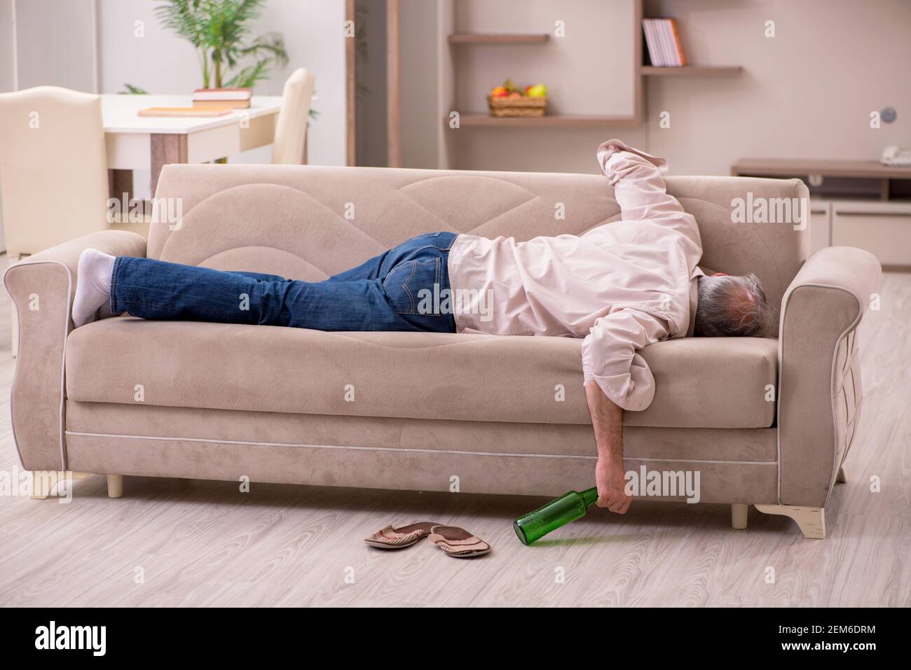 Aged man drinking alcohol at home Stock Photo - Alamy
